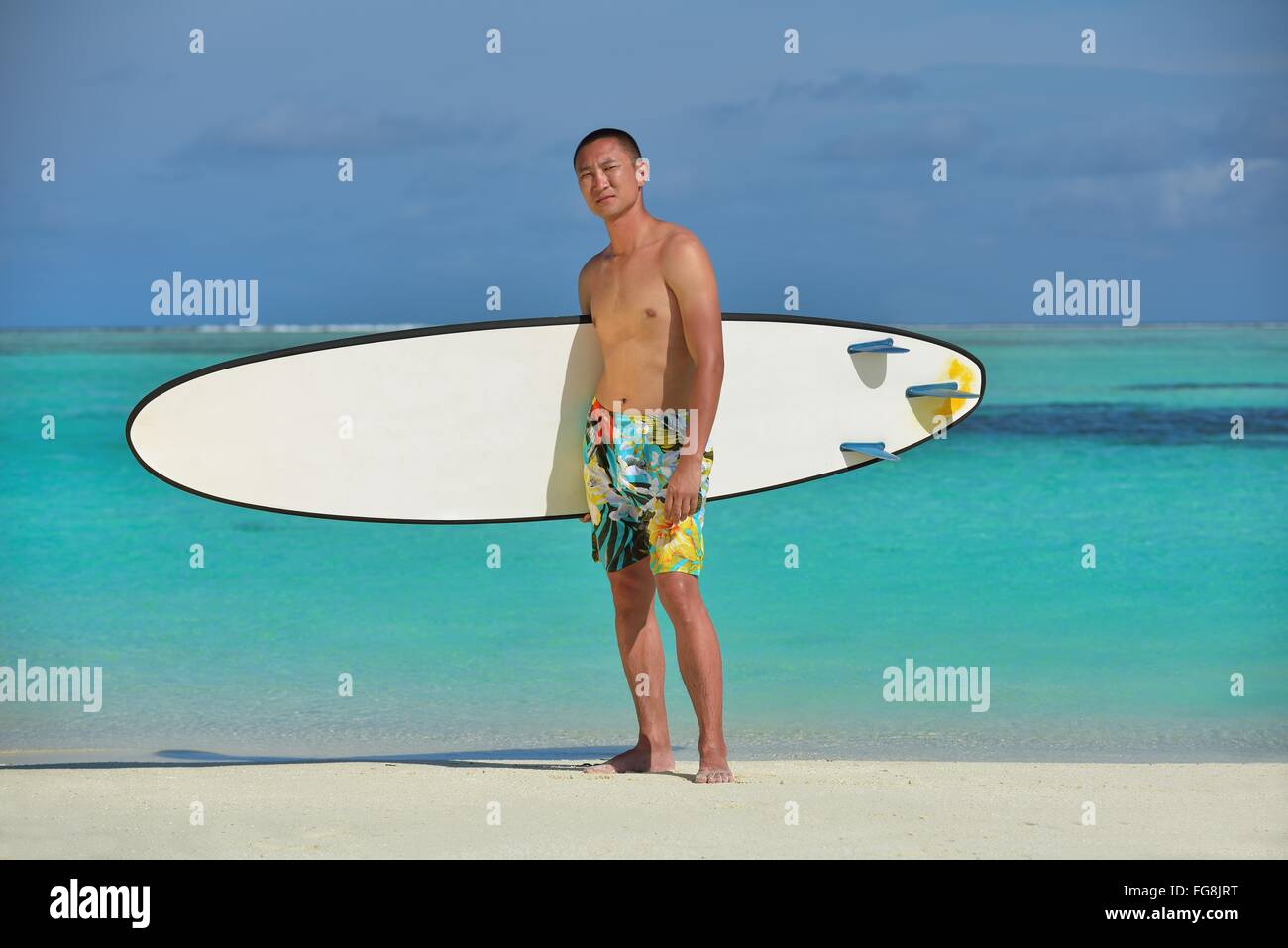 Man with surf board on beach Stock Photo - Alamy