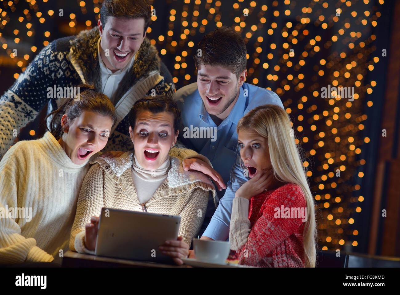 happy people looking at a tablet computer Stock Photo - Alamy