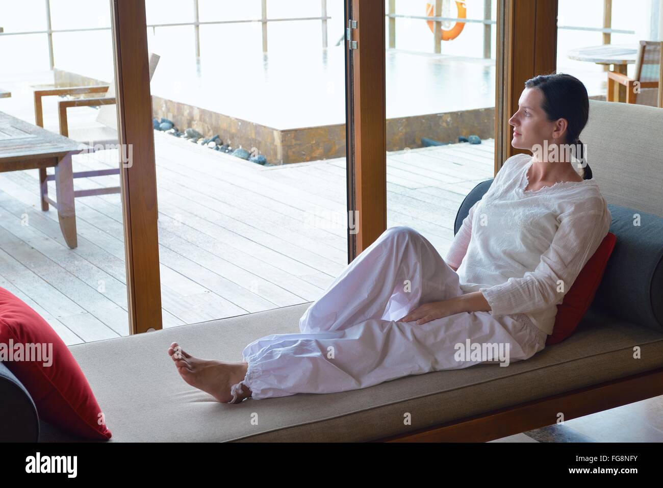 happy young woman relax at home on sofa Stock Photo - Alamy