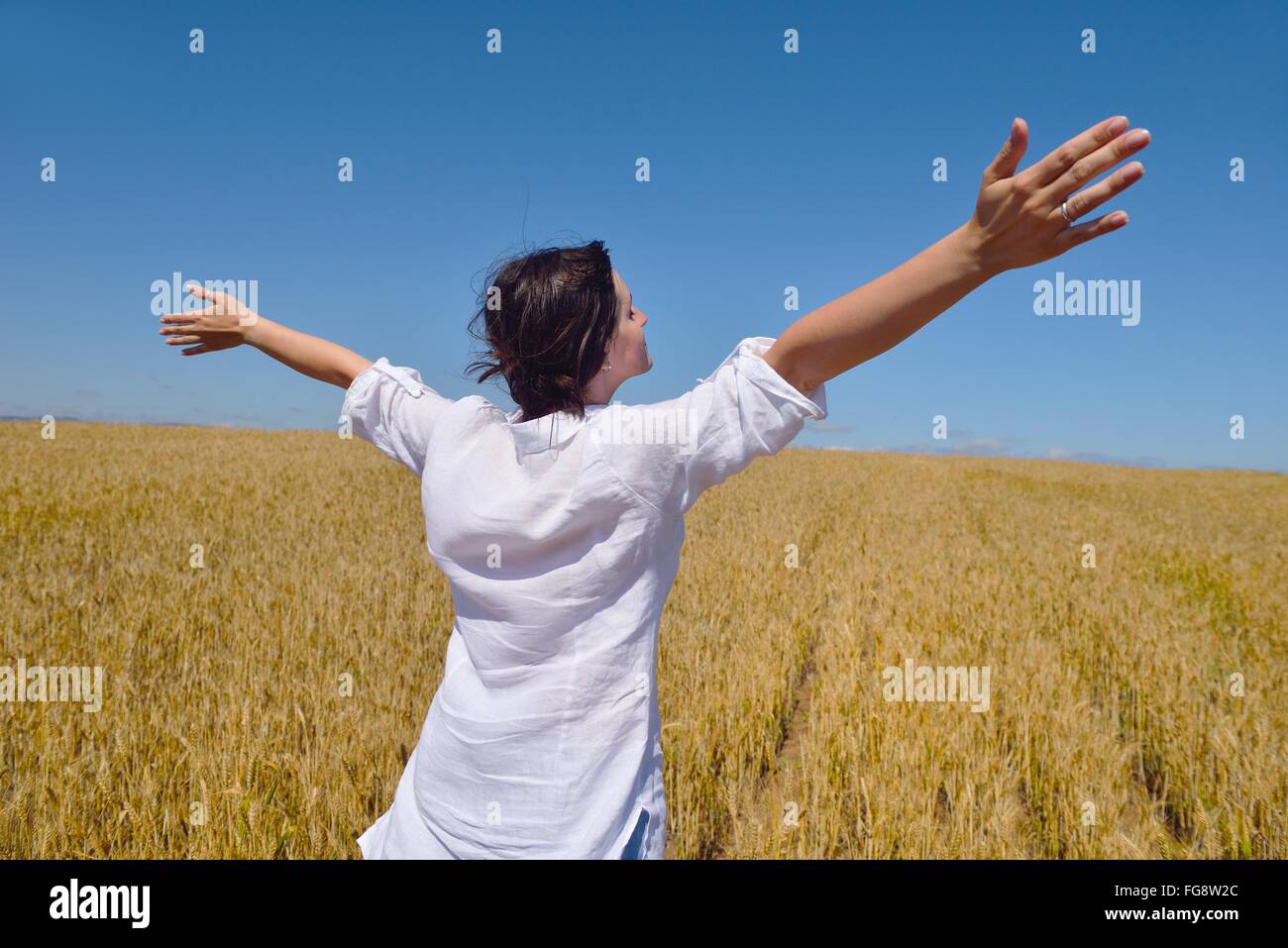 young woman with spreading arms to sky Stock Photo - Alamy