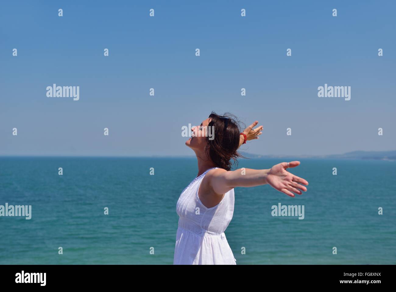 young woman with spreading arms to sky Stock Photo - Alamy