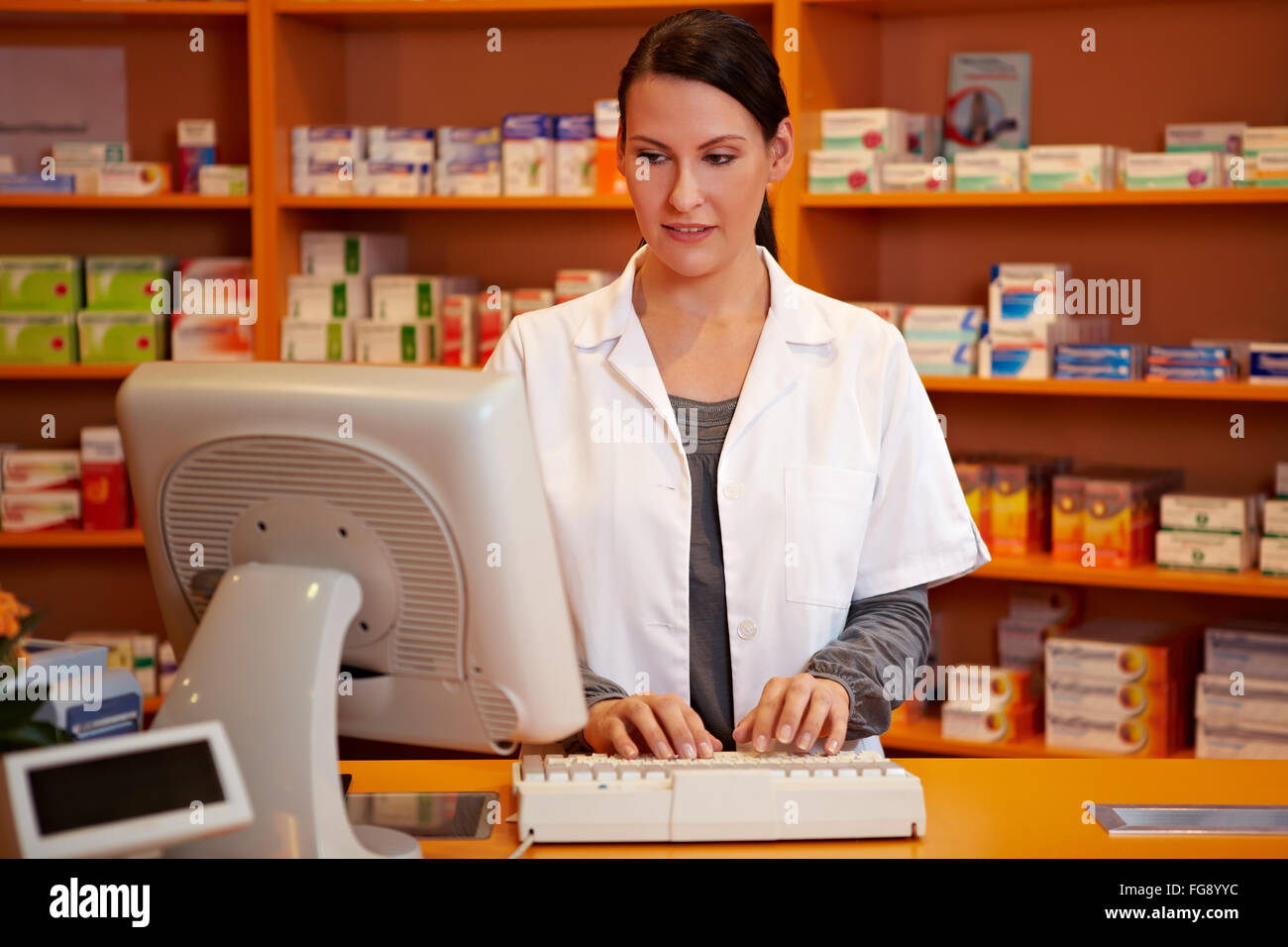 Pharmacist making an online order in a pharmacy Stock Photo - Alamy