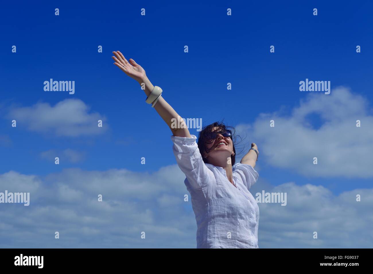 young woman with spreading arms to sky Stock Photo - Alamy