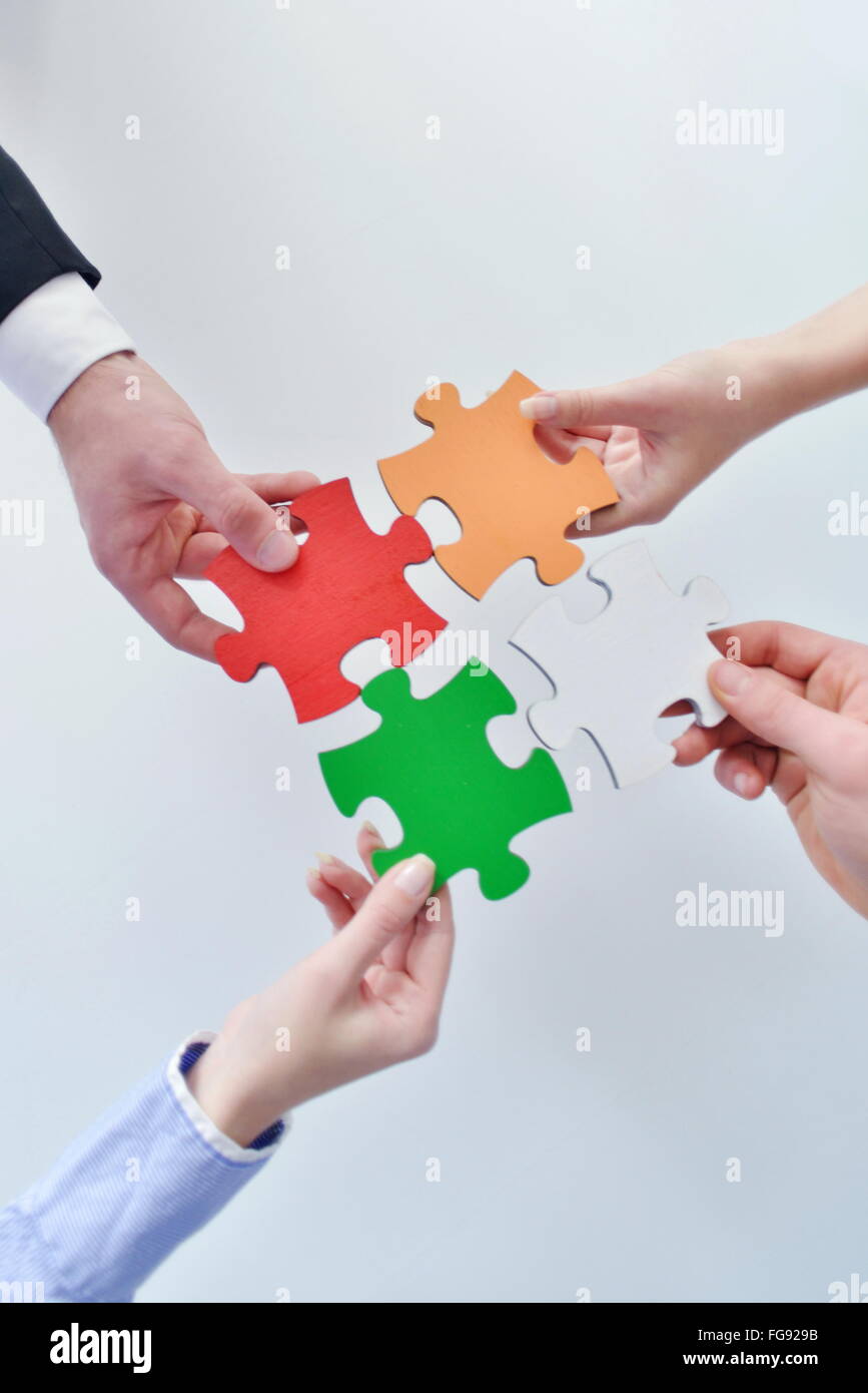 Group of business people assembling jigsaw puzzle Stock Photo - Alamy