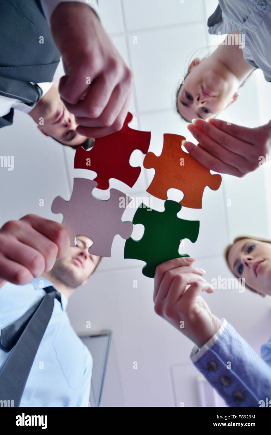 Group of business people assembling jigsaw puzzle Stock Photo - Alamy