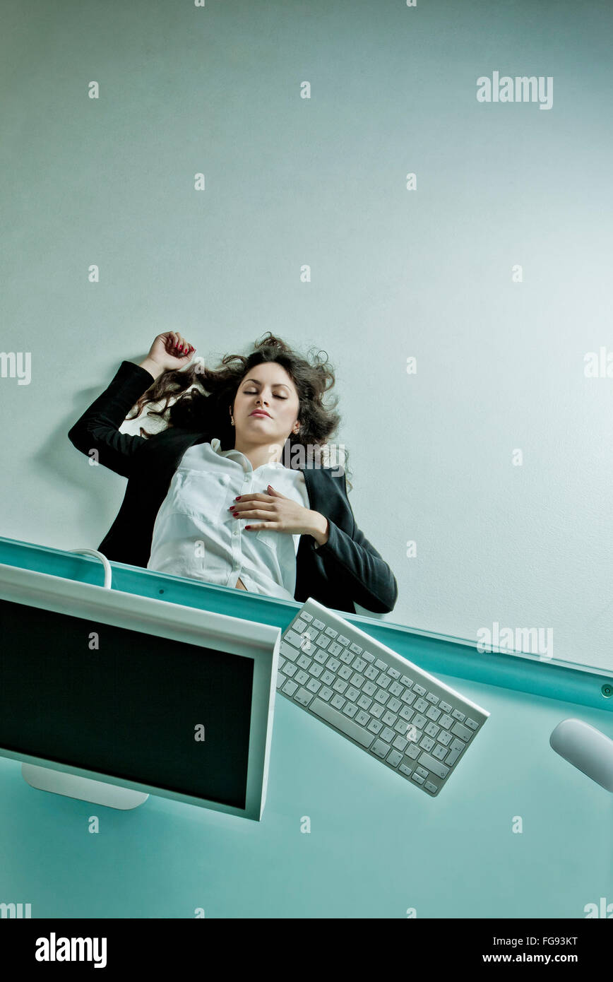 woman lying on the floor in the office Stock Photo - Alamy