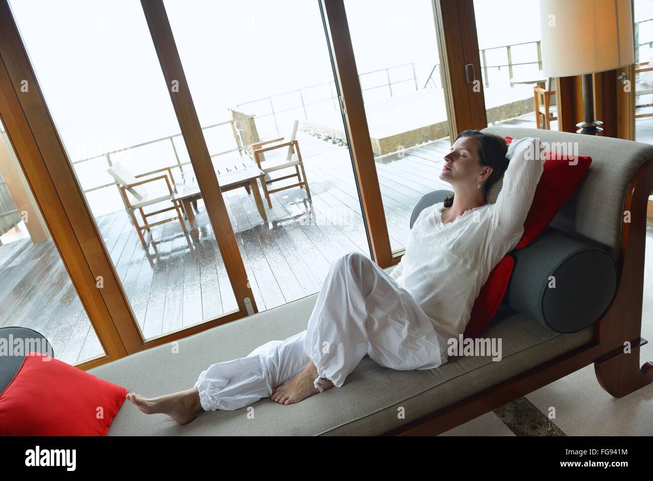 happy young woman relax at home on sofa Stock Photo - Alamy