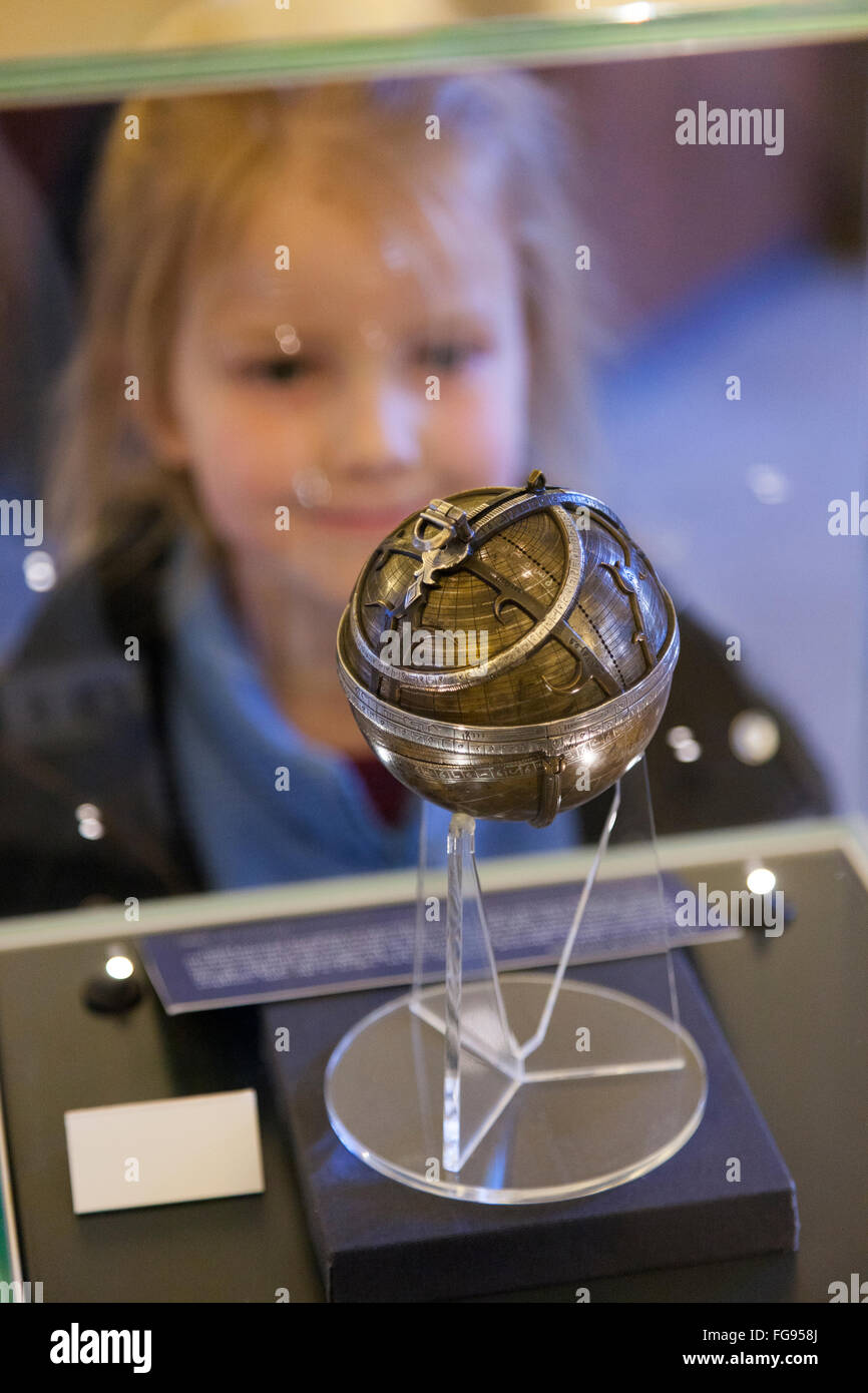 Young school age girl looking at display exhibit exhibition. Museum of ...
