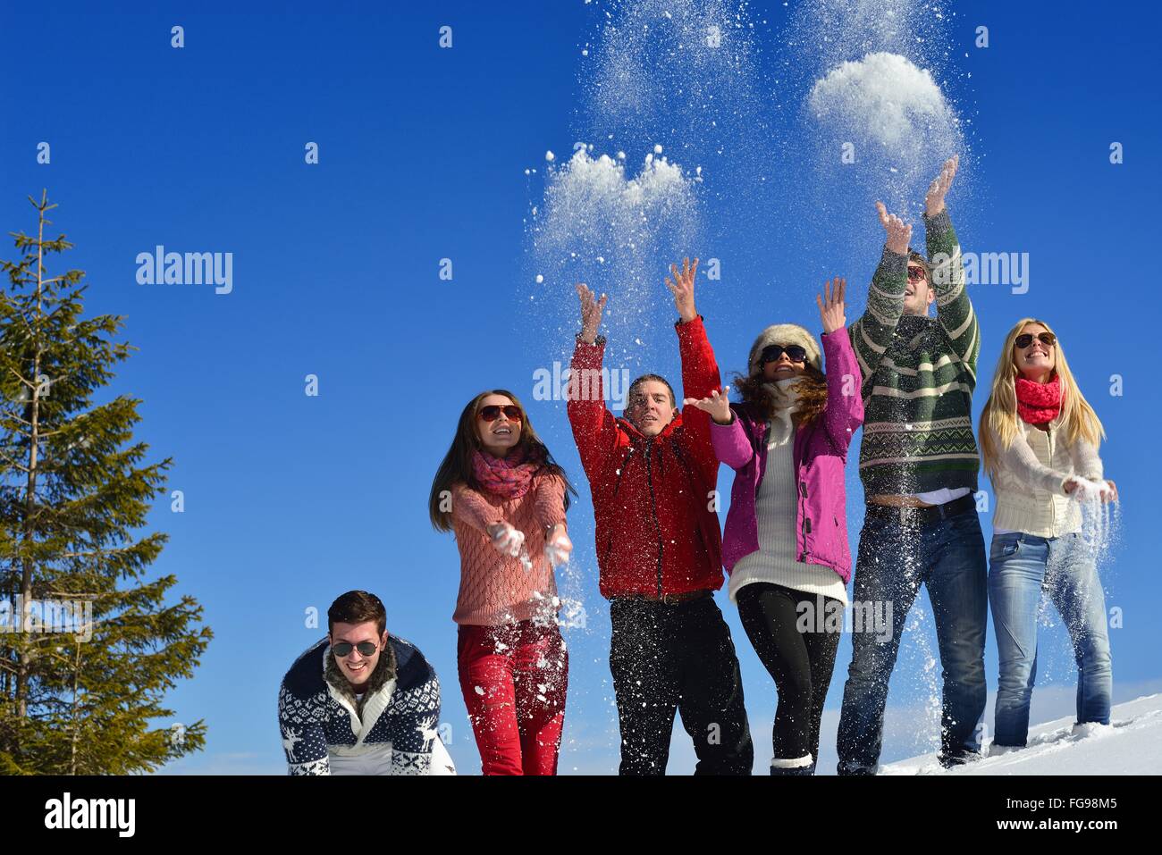 friends have fun at winter on fresh snow Stock Photo - Alamy