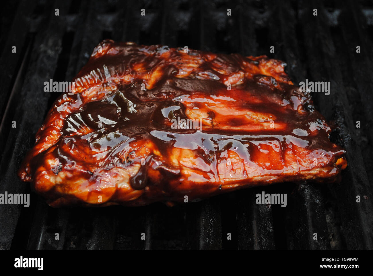 A Saucy Slab of Cooked Baby Back Ribs on the Grill Stock Photo - Alamy