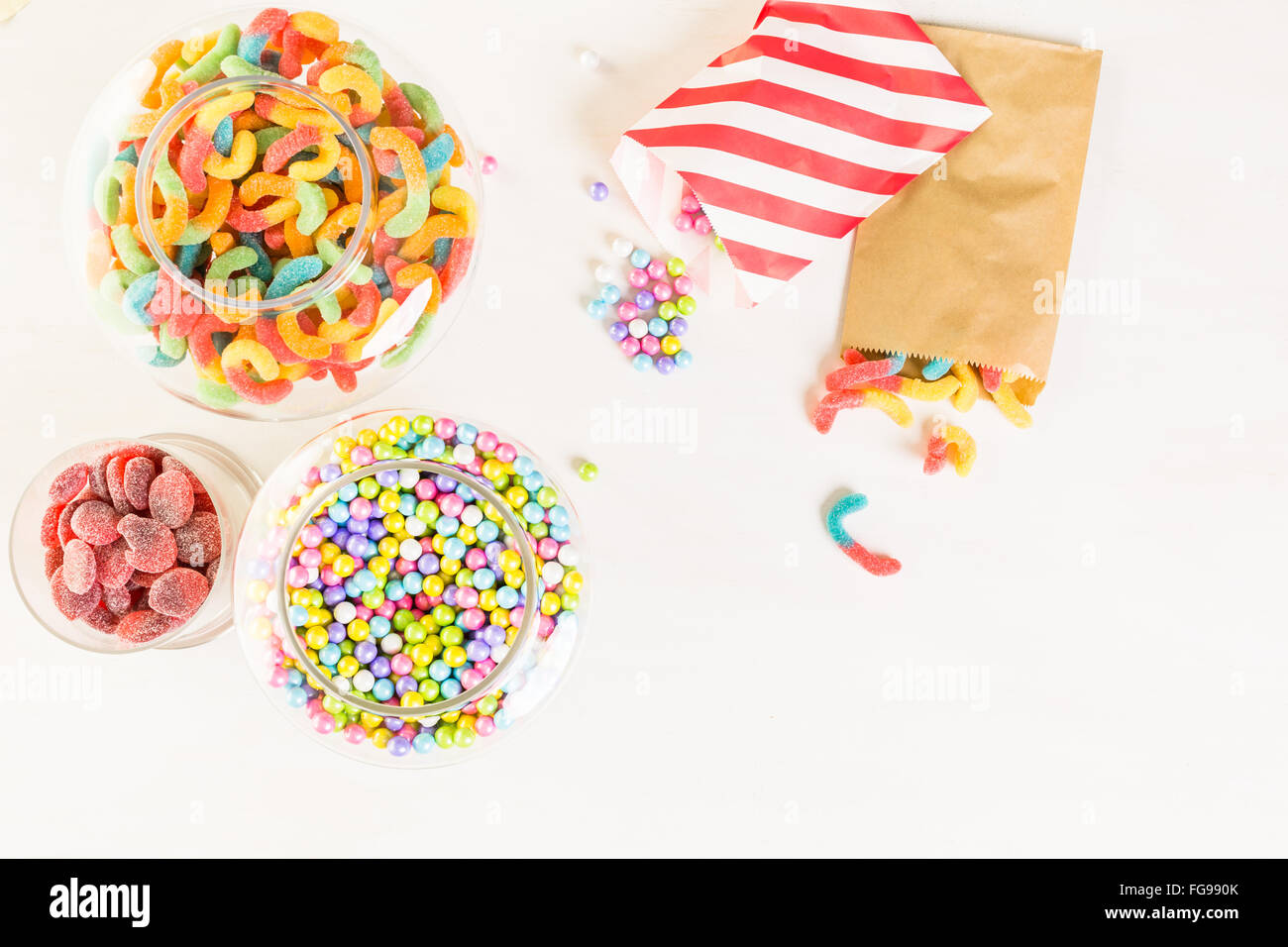Multicolored candies on a white table Stock Photo - Alamy