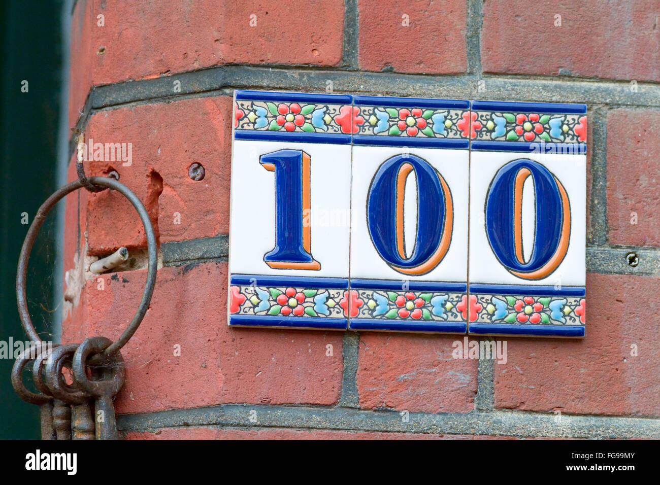 House number 100 sign and a ring of rusty keys Stock Photo - Alamy