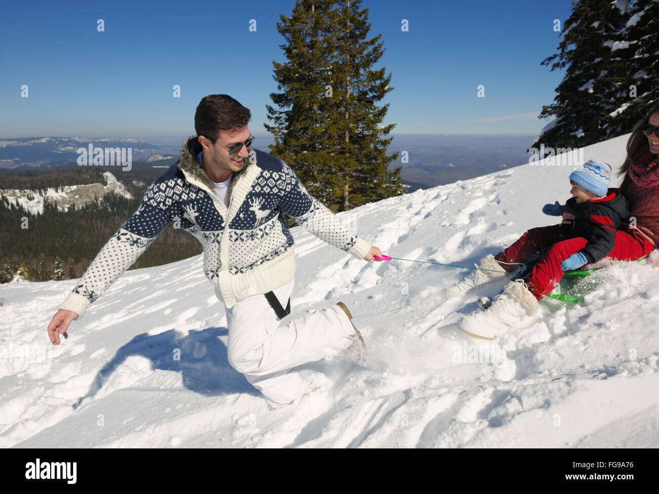 family having fun on fresh snow at winter Stock Photo - Alamy