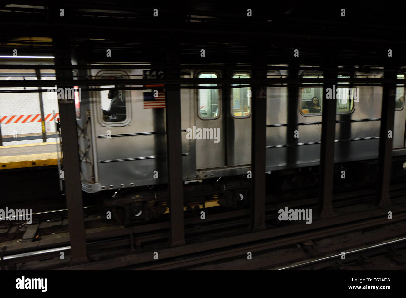 New York City Subway passing through a station Stock Photo - Alamy