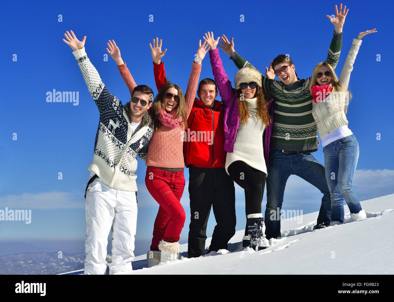 friends have fun at winter on fresh snow Stock Photo - Alamy