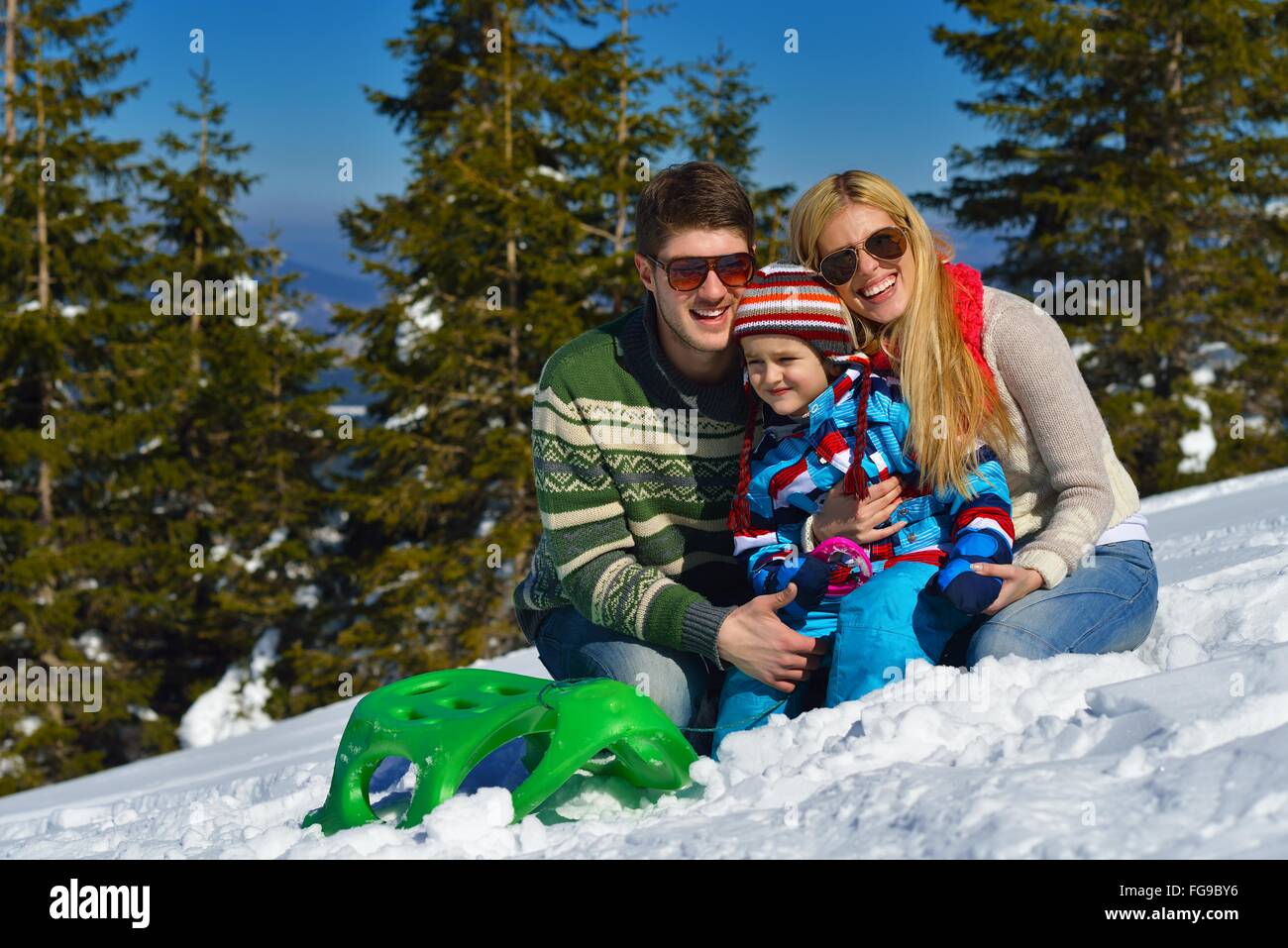 family having fun on fresh snow at winter Stock Photo - Alamy