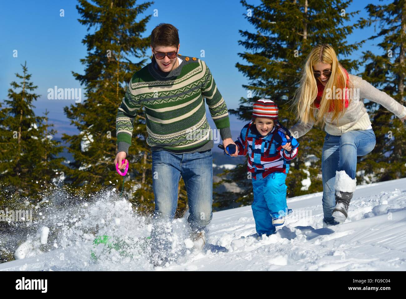family having fun on fresh snow at winter Stock Photo - Alamy