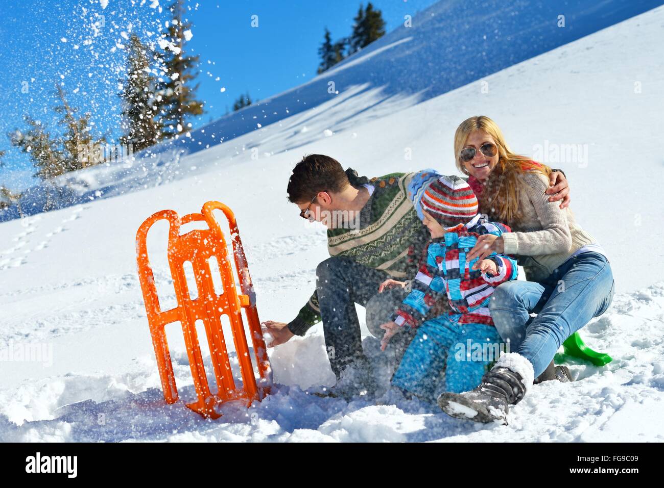 family having fun on fresh snow at winter Stock Photo - Alamy