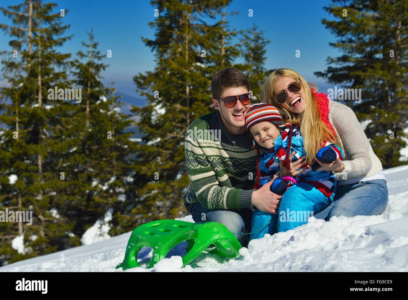 family having fun on fresh snow at winter Stock Photo - Alamy