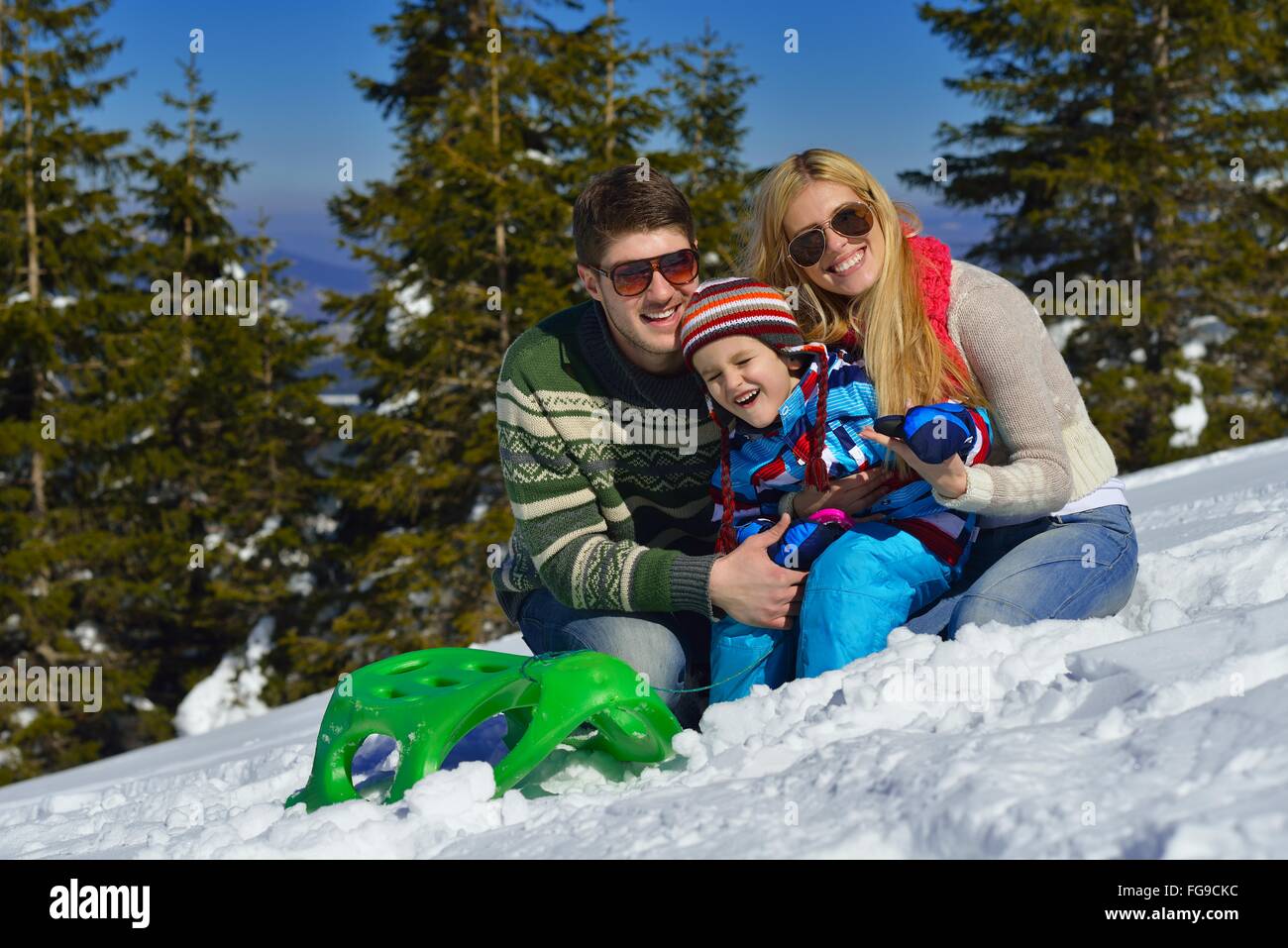 family having fun on fresh snow at winter vacation Stock Photo - Alamy