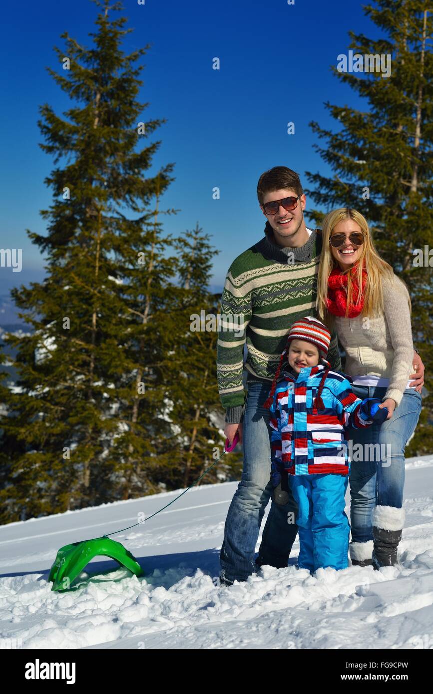 family having fun on fresh snow at winter vacation Stock Photo - Alamy