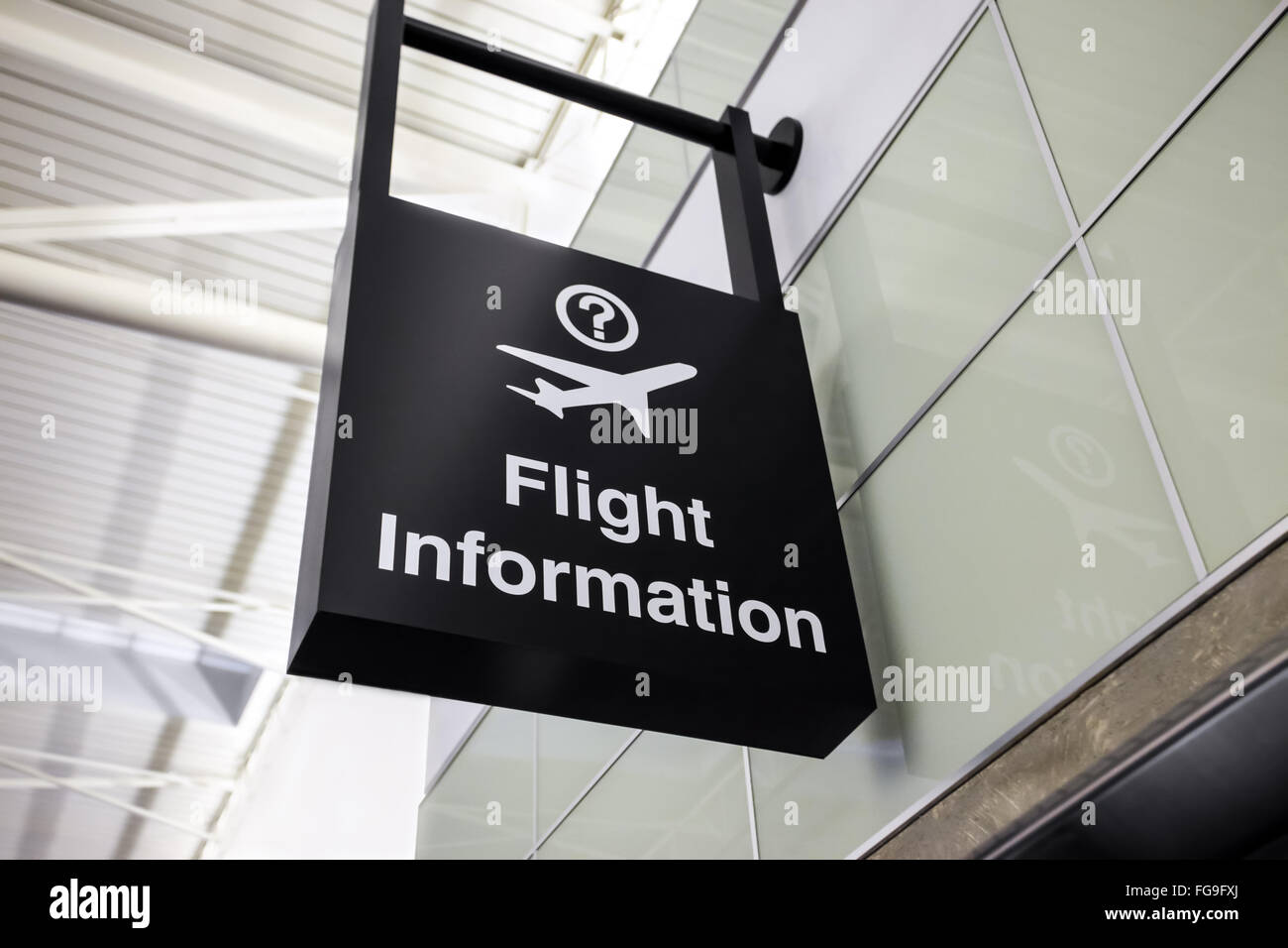 Airport flight information sign hanging on an interior wall Stock Photo ...