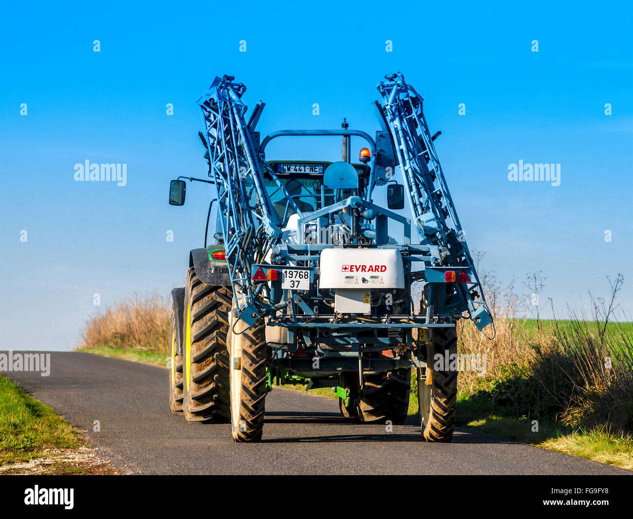 Evrard liquid fertiliser machine behind tractor on public road - France ...