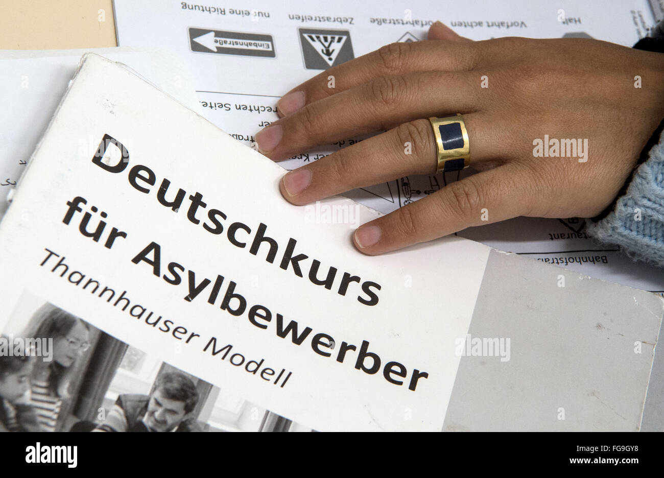 A young woman from Afghanistan studies the book 'German Course for ...