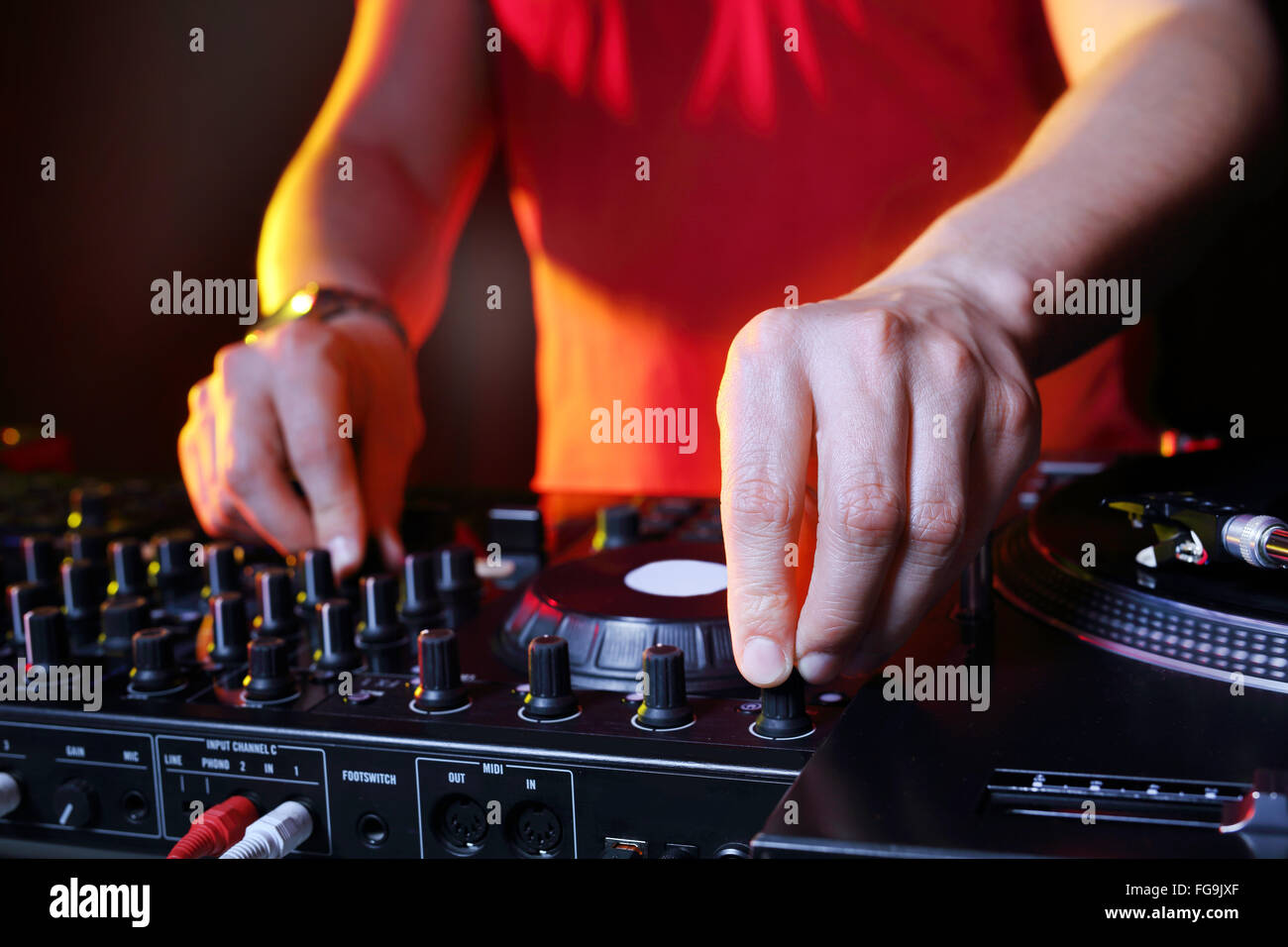 DJ. mixing music. Working in the club. Mixing console, DJ job in the ...