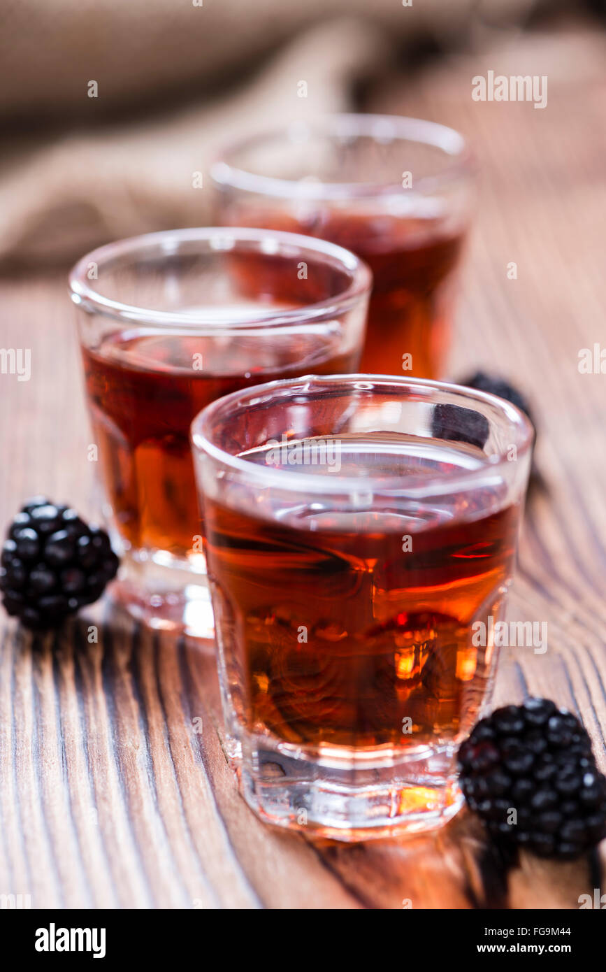 Blackberry Liqueur (as shot) on wooden background Stock Photo - Alamy