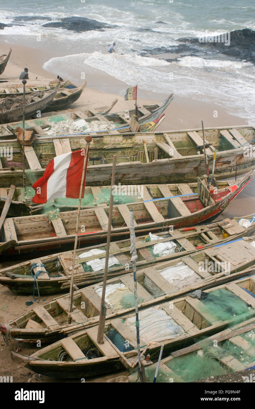 Pirogues, traditional wooden boats, sit on a beach ready for a day of ...