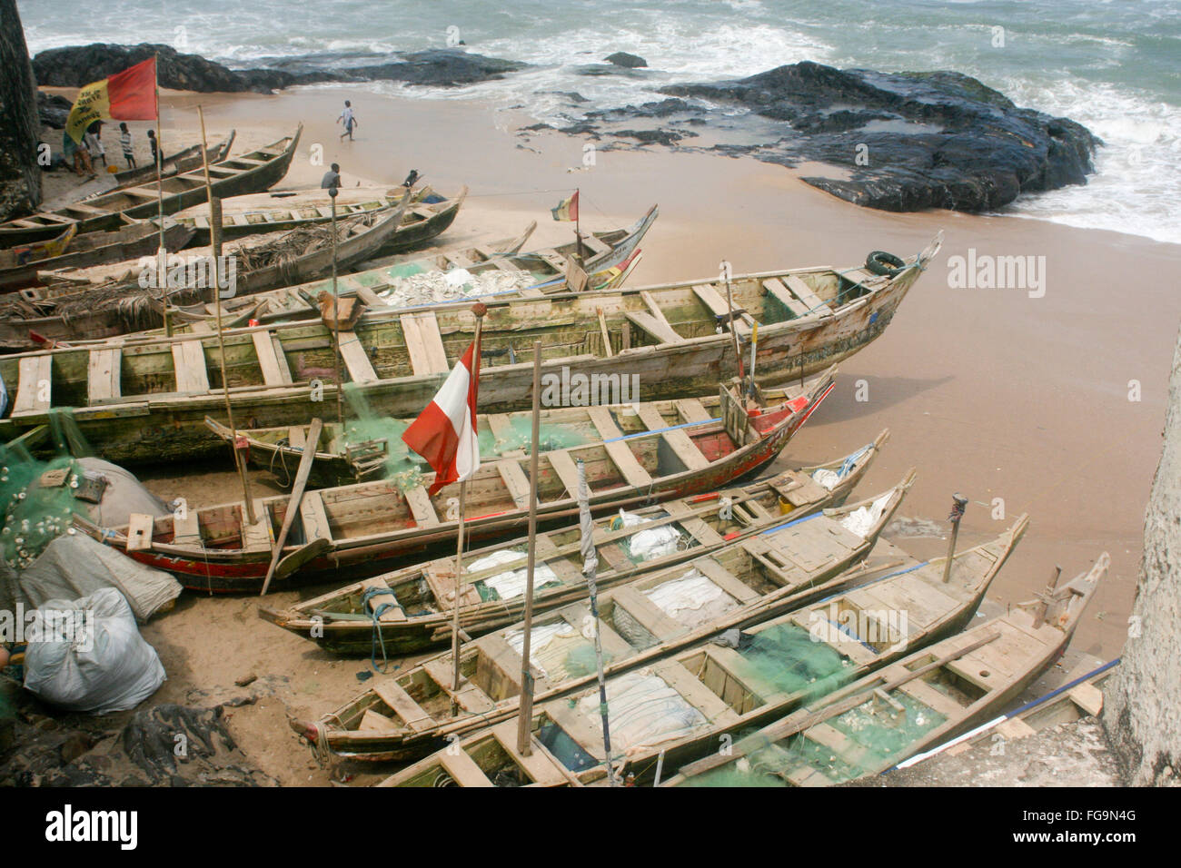 Pirogues, traditional wooden boats, sit on a beach ready for a day of ...