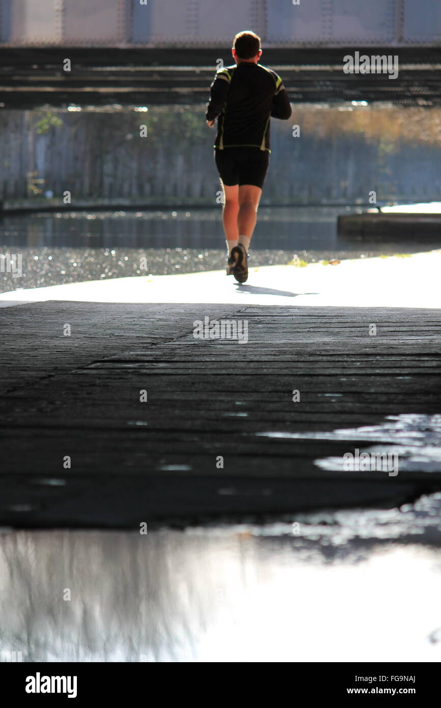 jogging run running river puddle reflection Stock Photo - Alamy