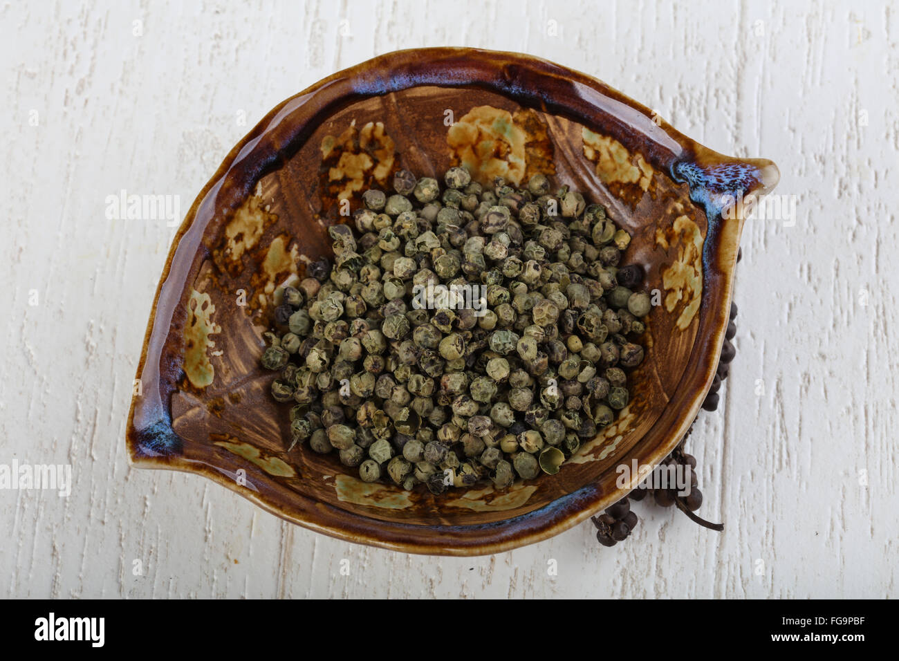 Dry Green pepper corn on the wood background Stock Photo - Alamy
