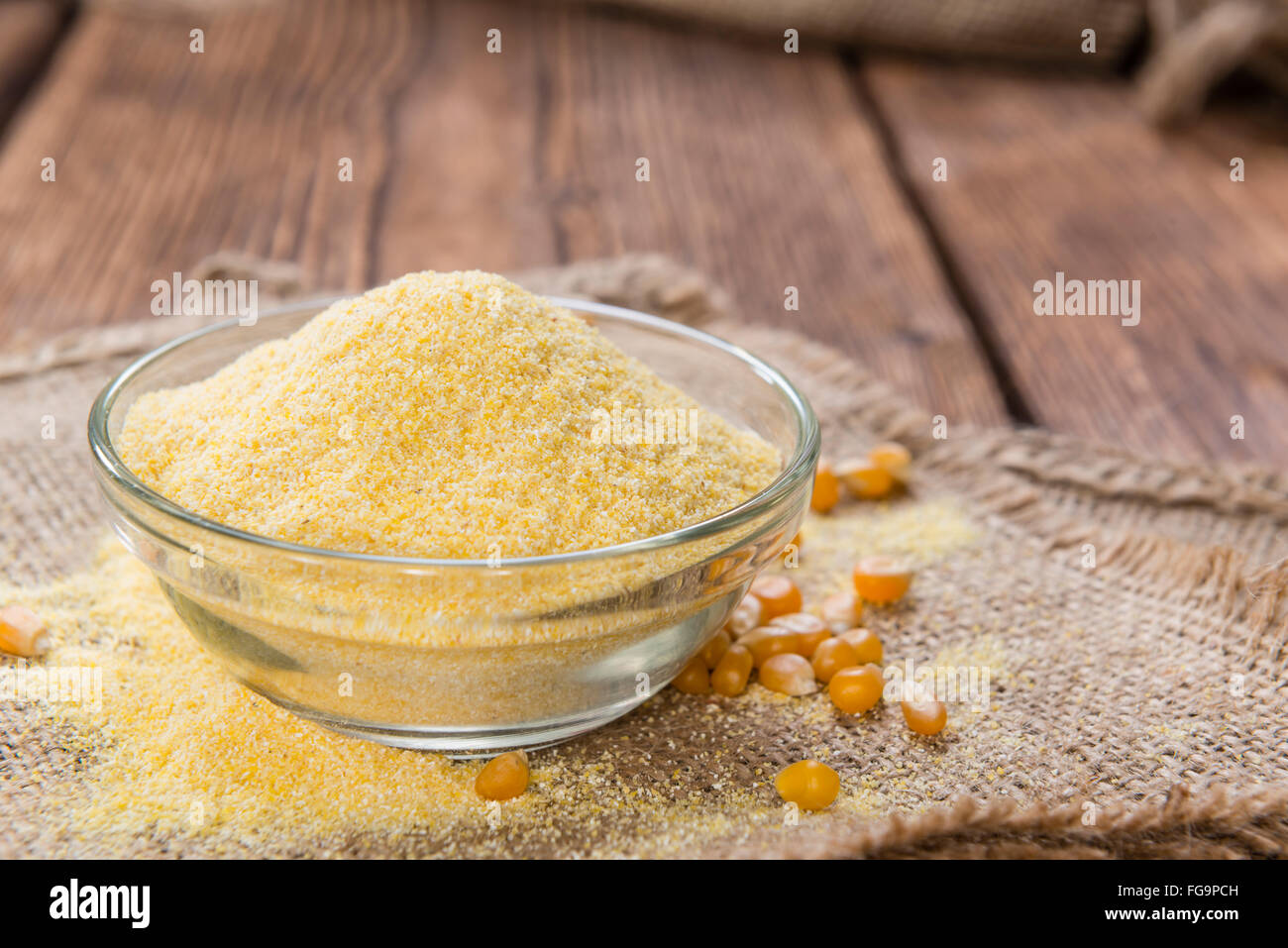 Portion of Cornmeal (on rustic background) as detailed close-up shot ...