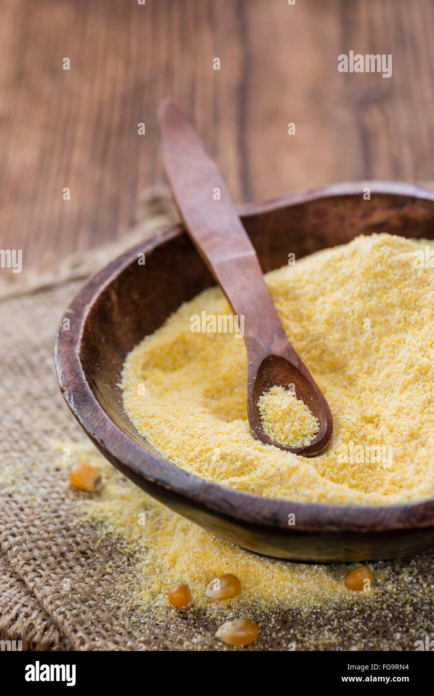 Portion of Cornmeal (on rustic background) as detailed close-up shot ...