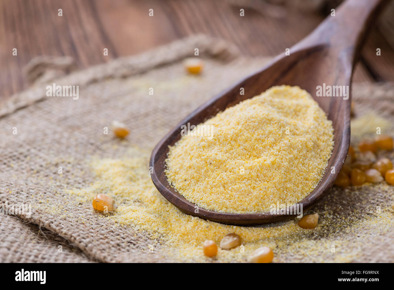 Portion of Cornmeal (on rustic background) as detailed close-up shot ...