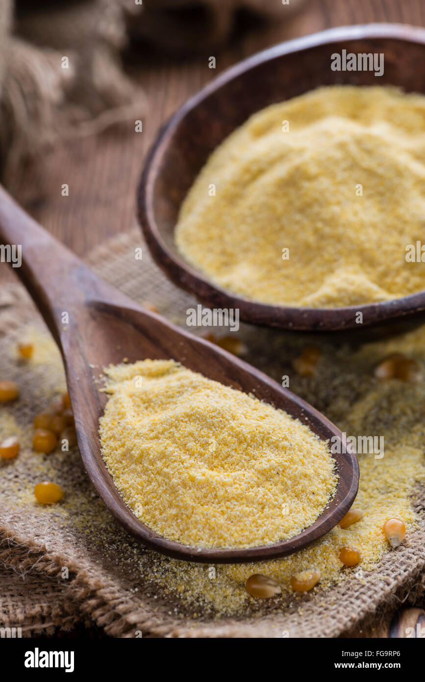 Portion of Cornmeal (on rustic background) as detailed close-up shot ...