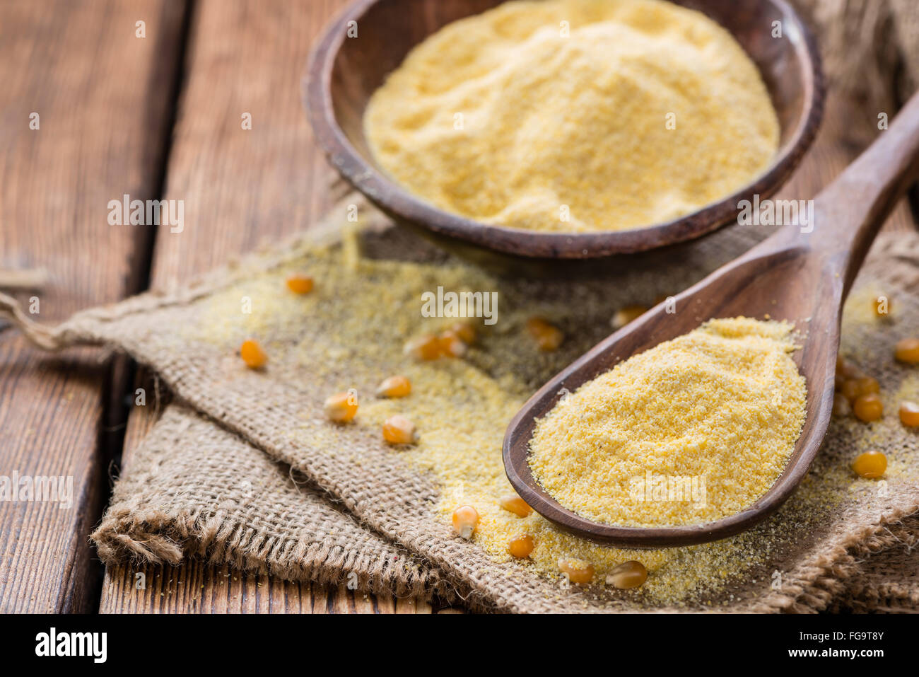 Portion of Cornmeal (on rustic background) as detailed close-up shot ...