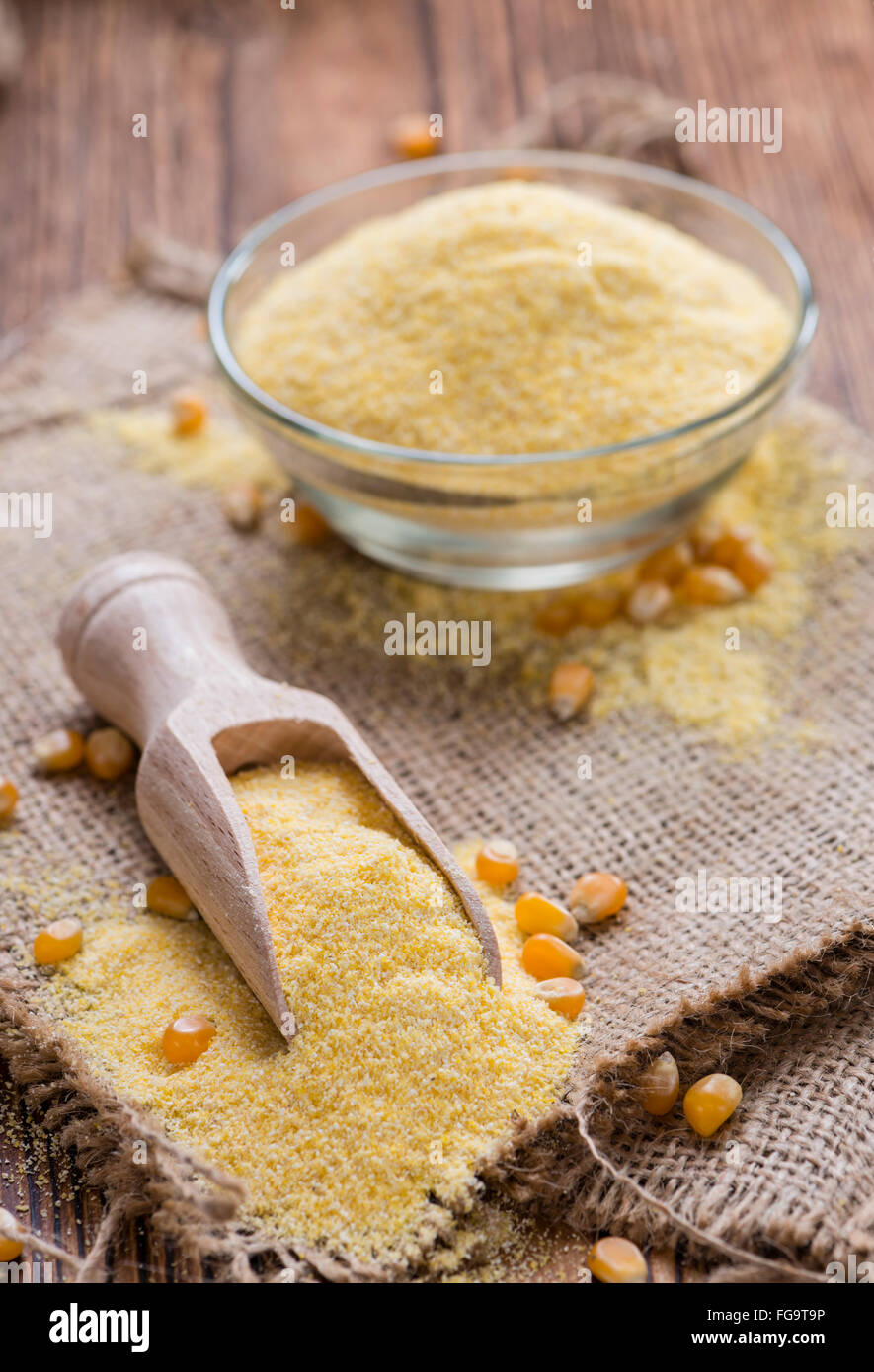 Portion of Cornmeal (on rustic background) as detailed close-up shot ...