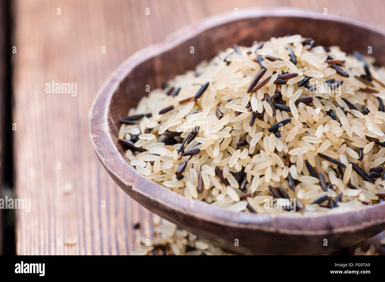 Uncooked Rice (mixed with wild Rice) on rustic background Stock Photo ...