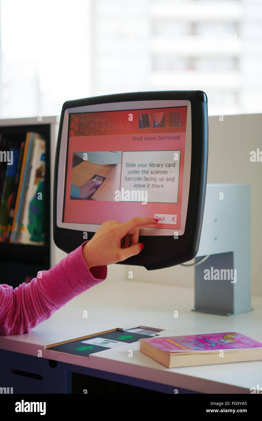 Young Girl Uses Self Service Library terminal to return books Stock ...