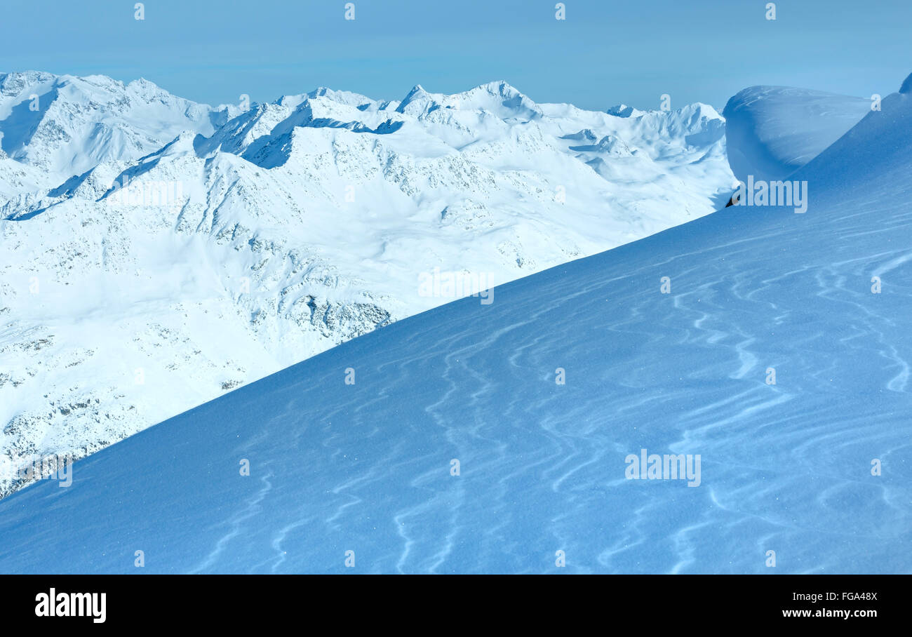 Winter mountain scenery from hill and shining snow on slope in front ...