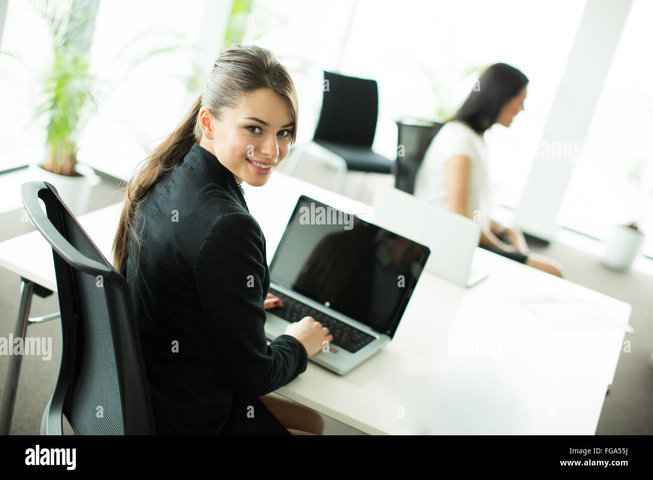 Young women working in the office Stock Photo - Alamy
