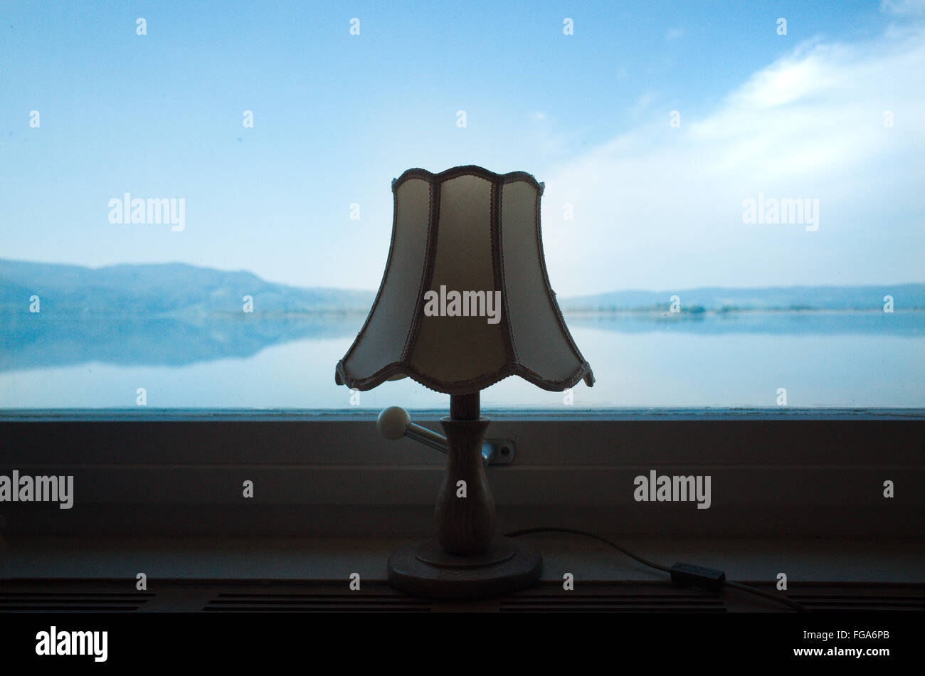Electric Lamp On Window Sill With Lake Seen In Background Stock Photo ...