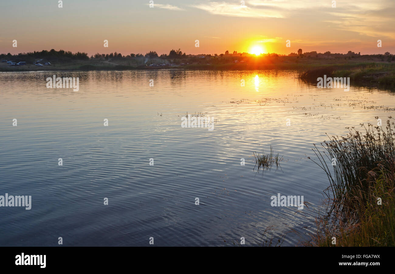 Sunset lake summer view with sun reflection Stock Photo - Alamy