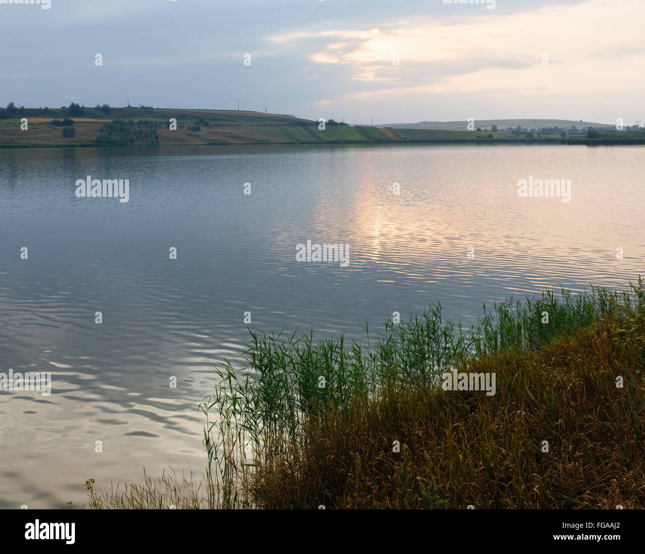 Evening lake scenery with sun reflection on water surface Stock Photo ...