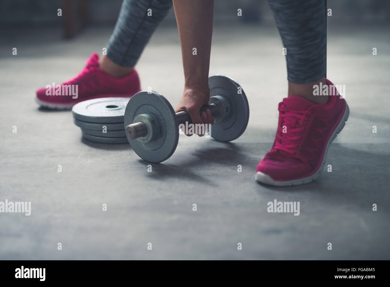 Body and mind workout in loft fitness studio. Closeup on woman lifting ...