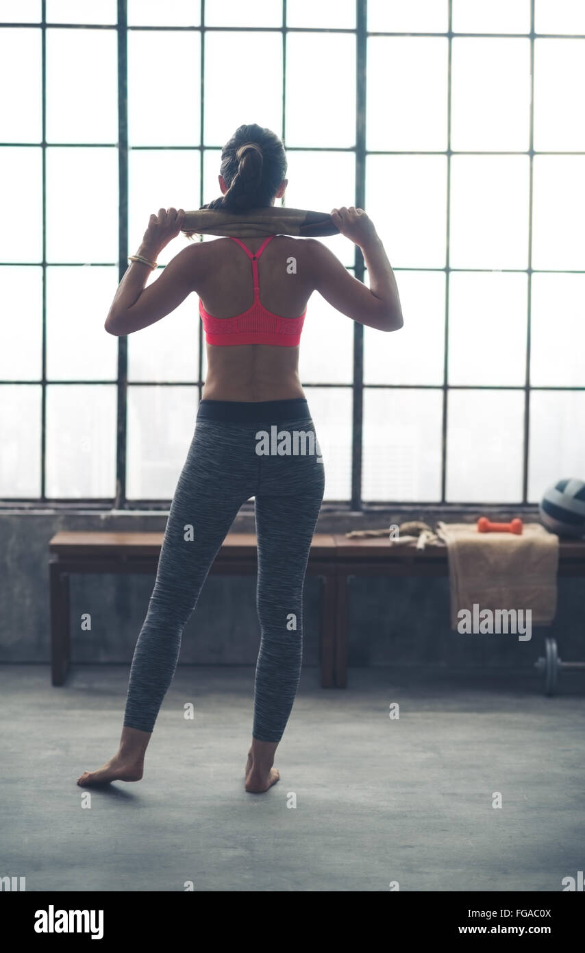 Body and mind workout in loft fitness studio. Seen from behind fitness ...