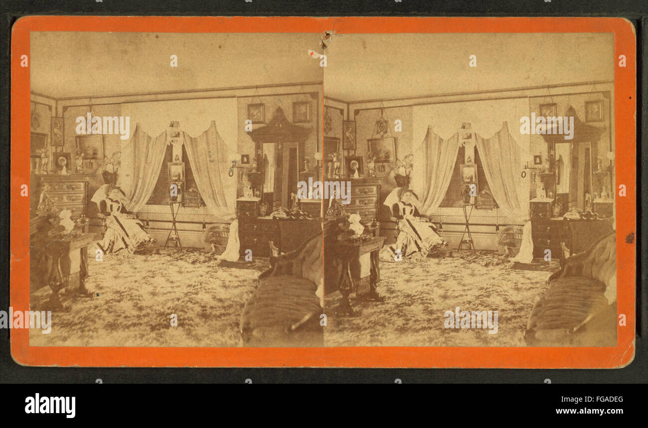 A photograph showing the interior of a parlor, with a woman sitting ...